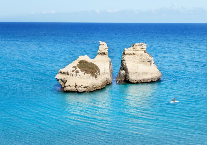 The Two Sisters Stacks in Front of the Shore of Torre Dell`Orso Stock ...