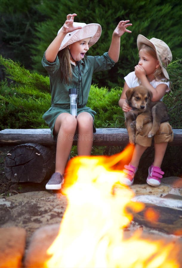 Two Sisters Talking Stories by the Campfire Stock Photo - Image of kids ...