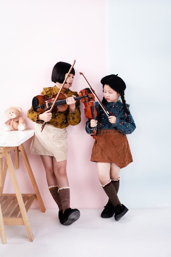 Two Sisters Talking Together,prepare for Playing Violin Stock Photo ...