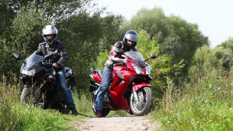 Two Sits on Grass, Then Sit Down on Motorcycles Stock Footage - Video ...