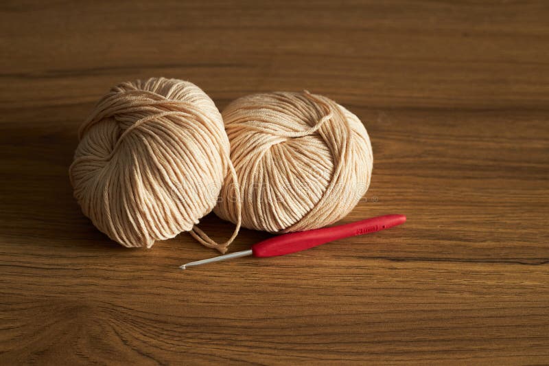 Two Skeins of Yarn for Knitting and Hook on the Table Stock Image ...