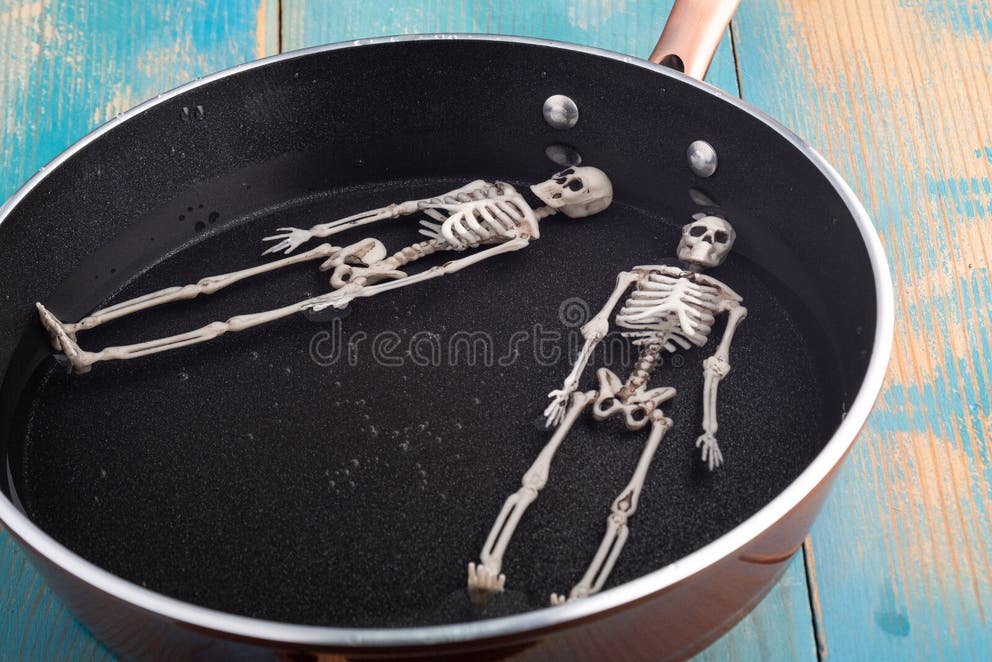 Two Skeletons Rest Lying on a Pan with Water in Which There are Bubbles ...