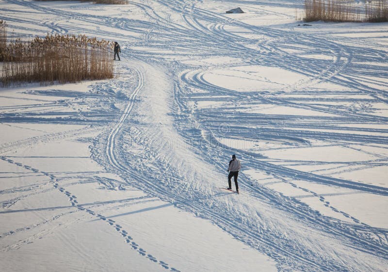 Two Skiers Skiing on the Frozen Surface of the River Stock Image ...