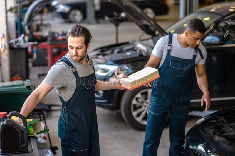 Two Skilled Mechanics Fixing the Customer Vehicle Stock Image - Image ...