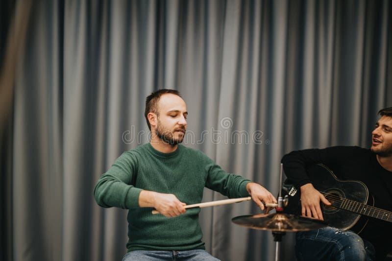Two Musicians Practicing Together in a Studio Setting with Instruments ...