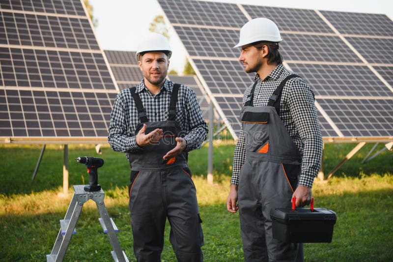 Two Skilled Workers or Craftsmen Wearing Working Gray Uniforms ...
