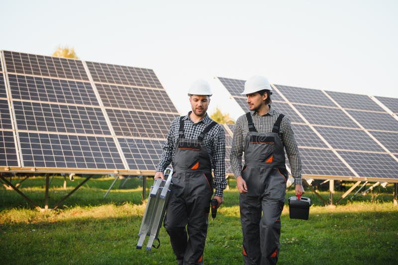 Two Skilled Workers or Craftsmen Wearing Working Gray Uniforms ...