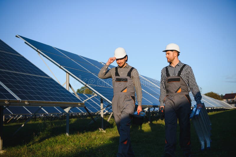 Two Skilled Workers or Craftsmen Wearing Working Gray Uniforms ...