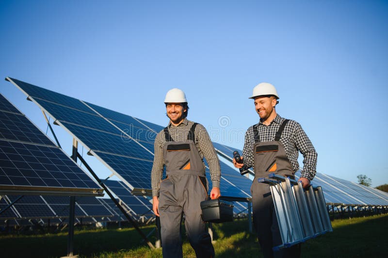 Two Skilled Workers or Craftsmen Wearing Working Gray Uniforms ...
