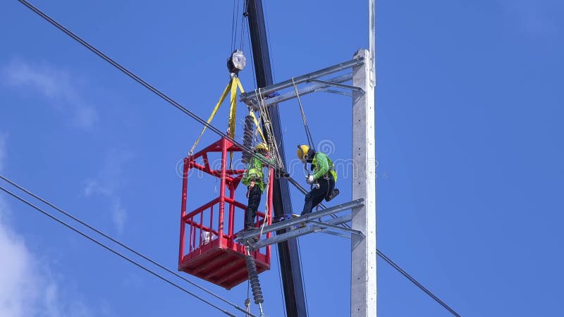 Two Skilled Workers on a Lift are Ensuring Safety during Electrical ...