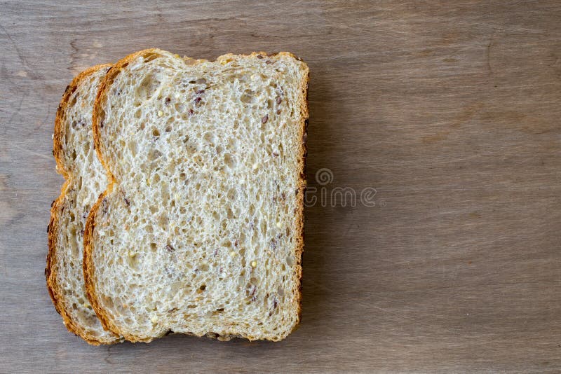 Two Slices of Bread Over Wooden Background Stock Photo - Image of grain ...
