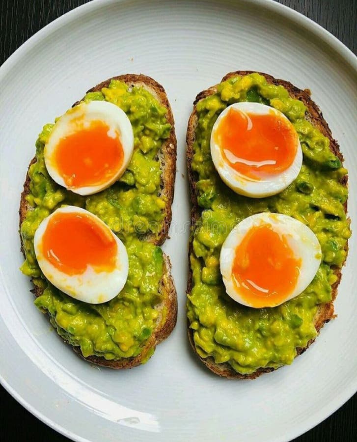 Two Slices of Bread Smeared with Avocado Jam and Topped with Two Eggs ...