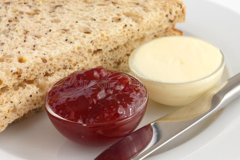 Two Slices of Multigrain Bread with Jam and Butter Stock Photo - Image ...