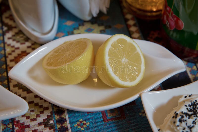 Two Slices of Yellow Lemon Plate. Lemon Cut in Half. the Two Halves of ...