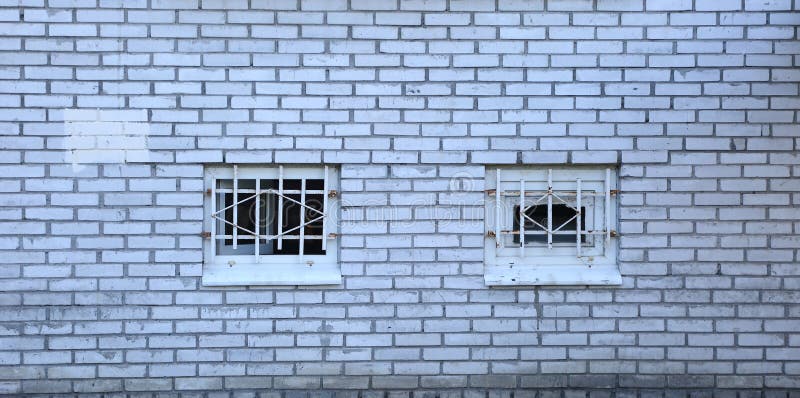Two Small Barred Windows in a White Brick Wall Stock Photo - Image of ...