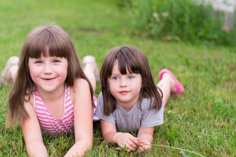 Two Small Children on the Grass Stock Photo - Image of happiness ...