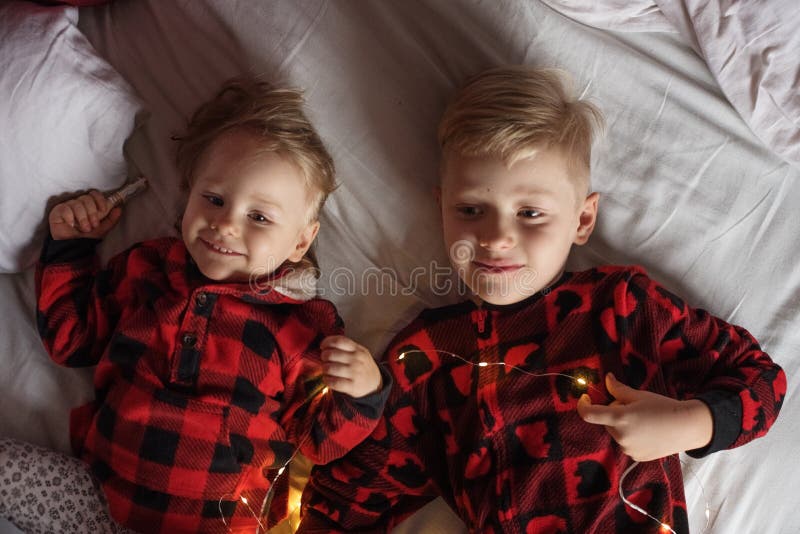 Two Small Children are Lying on the Bed and Having Fun. Preparation for ...