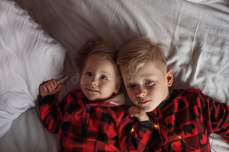 Two Small Children are Lying on the Bed and Having Fun. Preparation for ...
