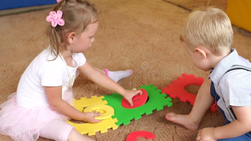 Two Small Children Play with a Large Soft Puzzle. Stock Video - Video ...