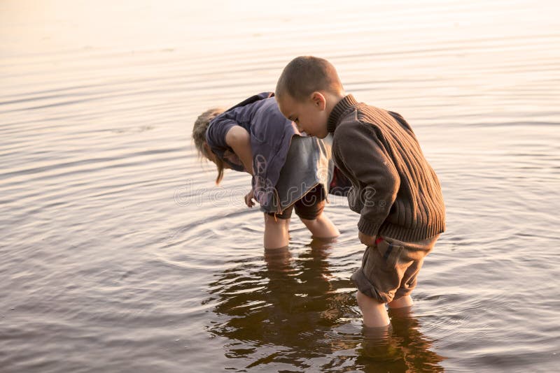 Two Small Children are Playing in the River Stock Image - Image of ...