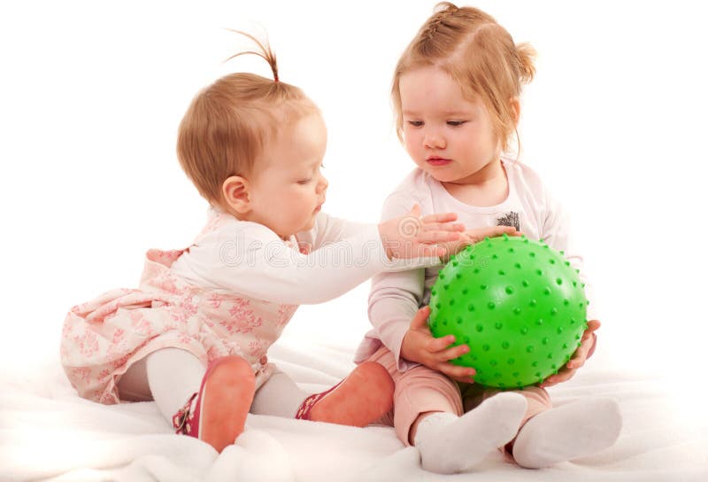 Two Small Girls Playing with Ball Stock Photo - Image of closeup, tool ...