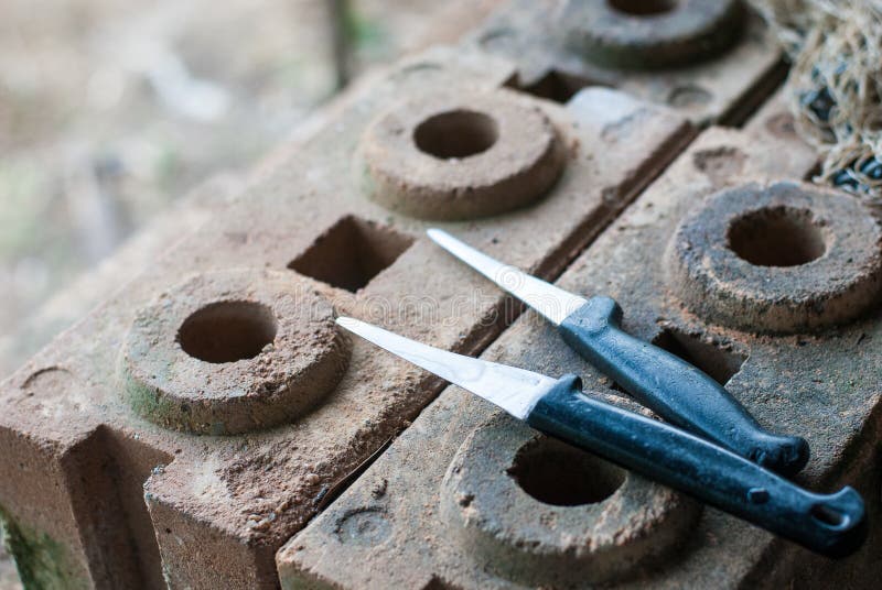 Two Small Knives with Black Handle Placed on Red Construction Brick ...