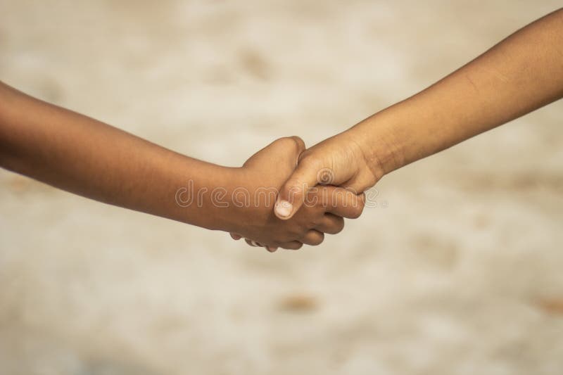 Two Small People are Shaking Hands and the Background is Blurred Stock ...