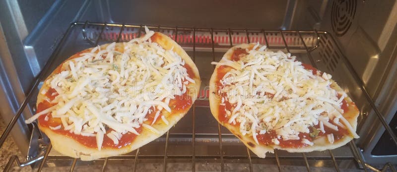 Two Small Pizzas Cooking in a Toaster Oven Stock Image - Image of ...
