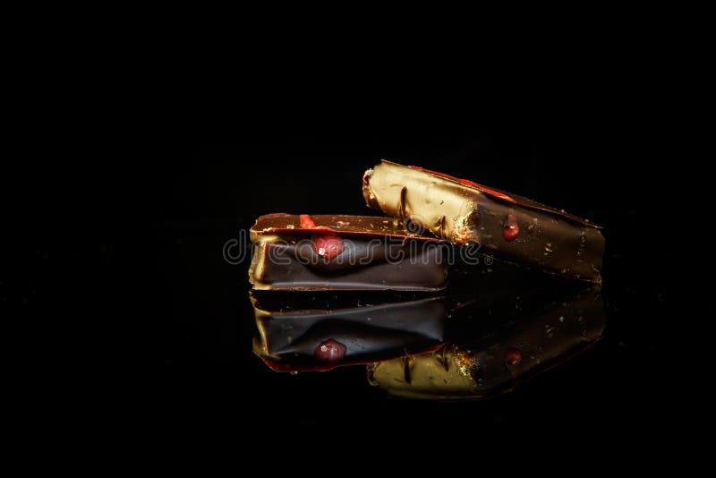 Two Small Square Chocolate Candies on Black Background Stock Image ...