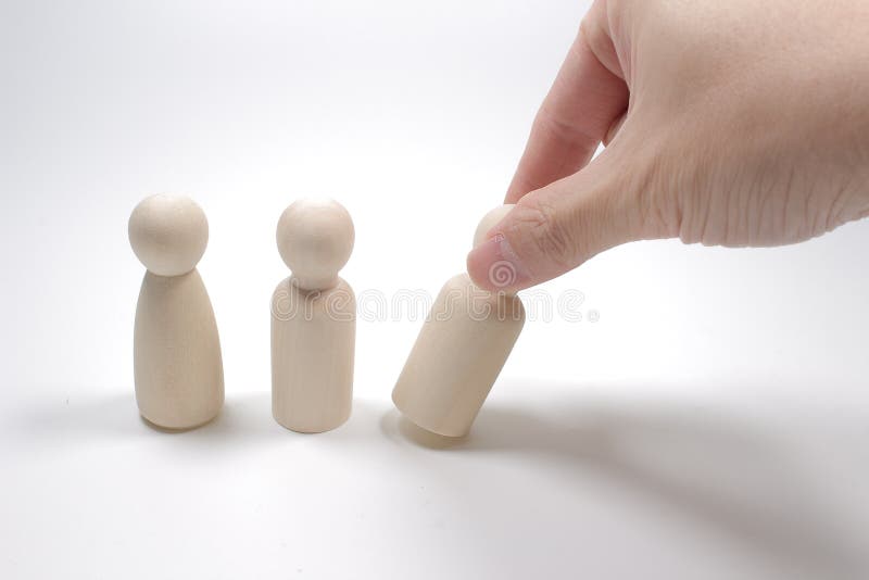 A Two Small Wooden Figures are Looking for Hand Puts or Removes Big ...