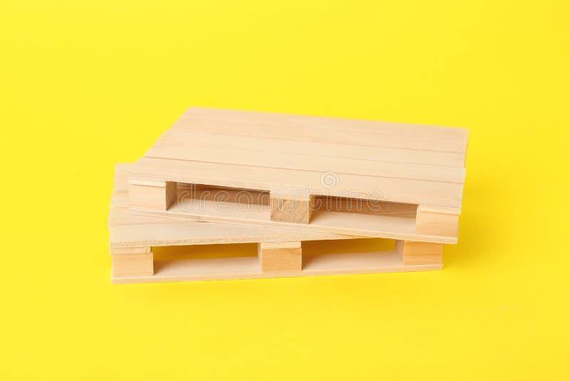 Two Small Wooden Pallets on Yellow Background Stock Image - Image of ...