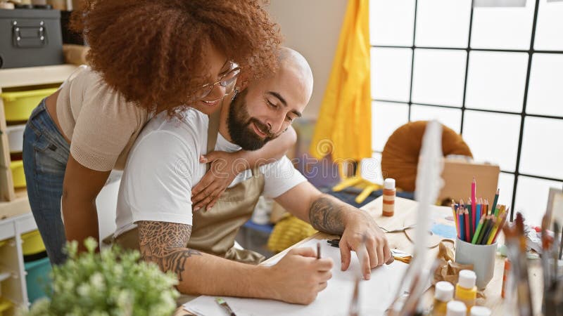 Two Smiling Artists, Hugging and Drawing Together in an Art Studio ...