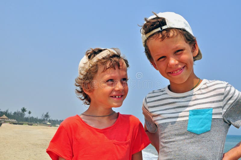 Two smiling boys stock image. Image of sand, people, boys - 53387653