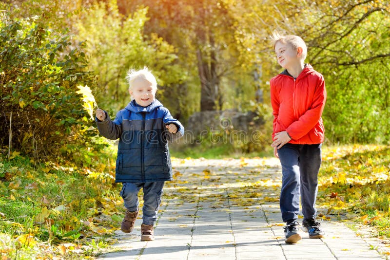 Two Smiling Boys Run through the Autumn Park Stock Image - Image of ...