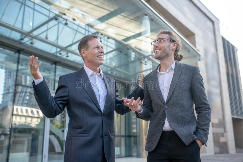 Two Smiling Businessmen Having Friendly Conversation Outside Stock ...