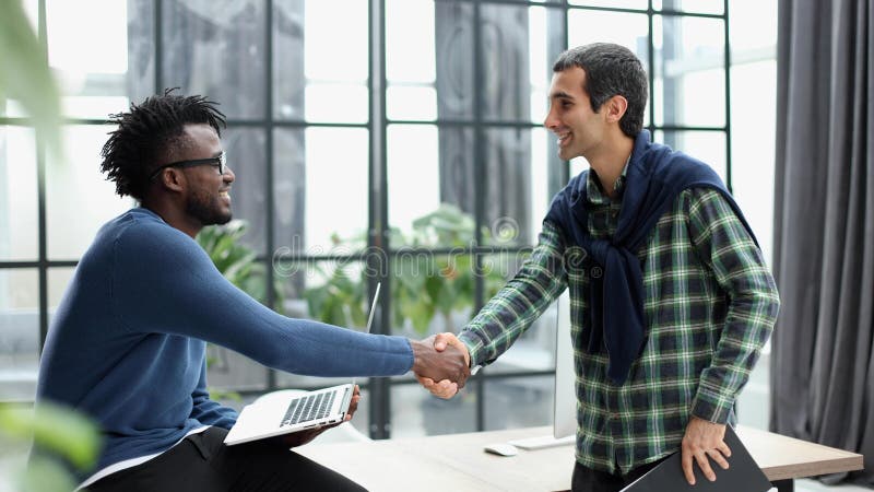 Two Smiling Businessmen Shaking Hands Together while Standing by ...