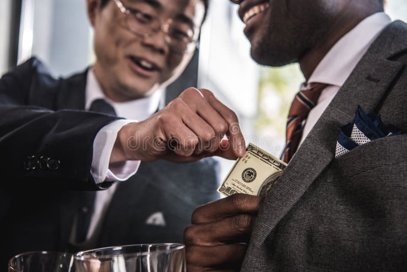 Two Smiling Businessmen Talking and Holding Dollar Banknote Stock Photo ...