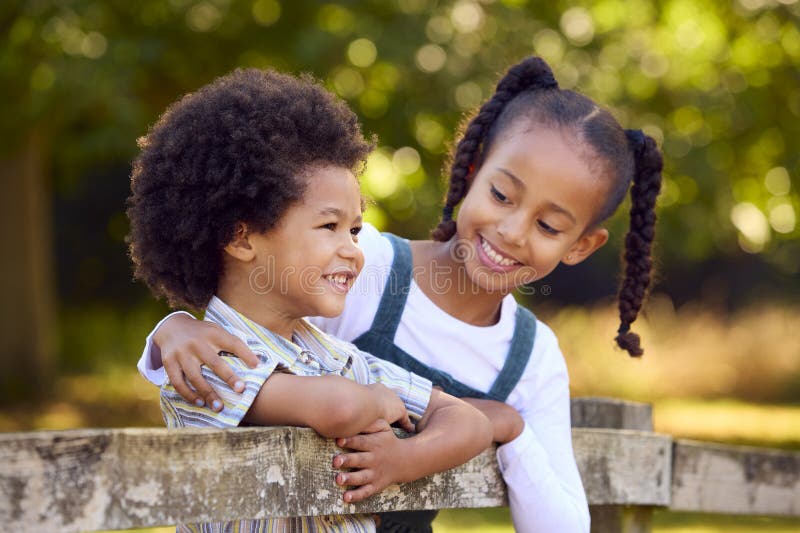 Two Smiling Children Leaning on Fence on Walk in Countryside Stock ...