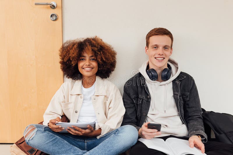 Two Smiling Classmates Looking at Camera. Cheerful Students Sitting ...