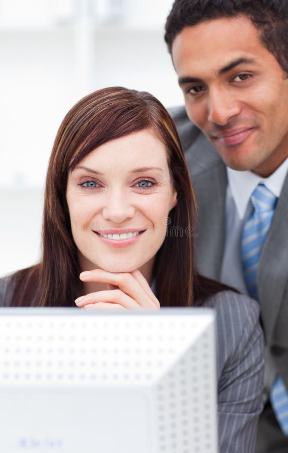 Two Smiling Colleagues Working at a Computer Stock Image - Image of ...