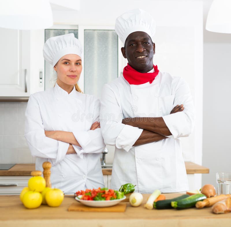 Two Smiling Confident Personal Chefs in White Uniforms Standing in ...