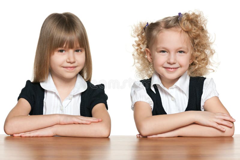 Two Smiling Girls at the Desk Stock Image - Image of white, cute: 32863581