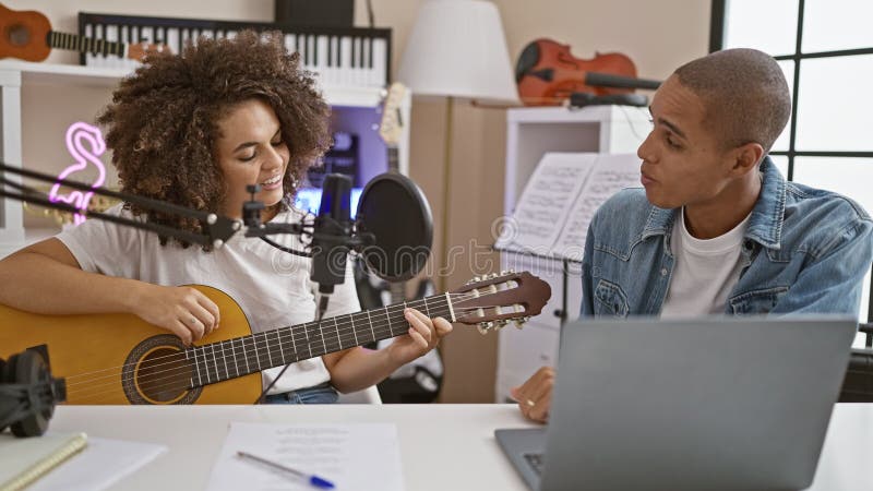 Two Smiling Musicians Packed in a Cozy Studio, Strumming the Classic ...