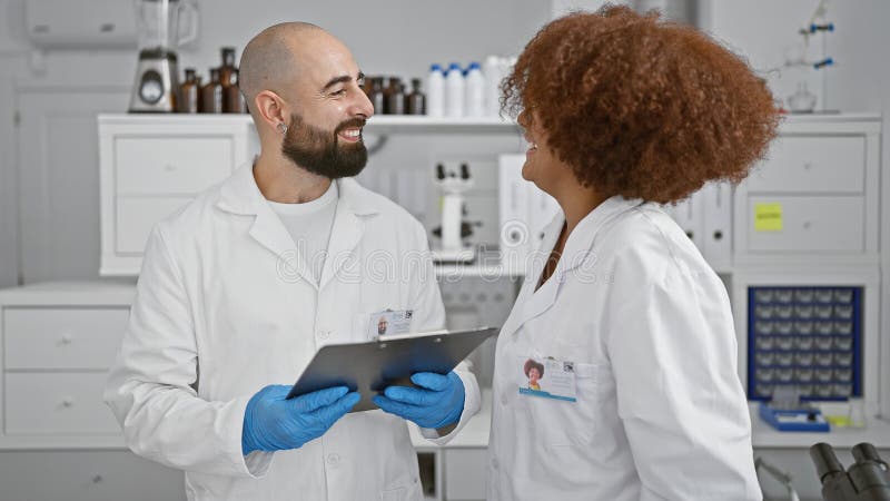 Two Smiling Scientists in the Lab, Engrossed in a Lively Chat while ...