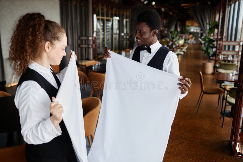 Young Woman As Female Server Setting Table in Restaurant Preparing for ...