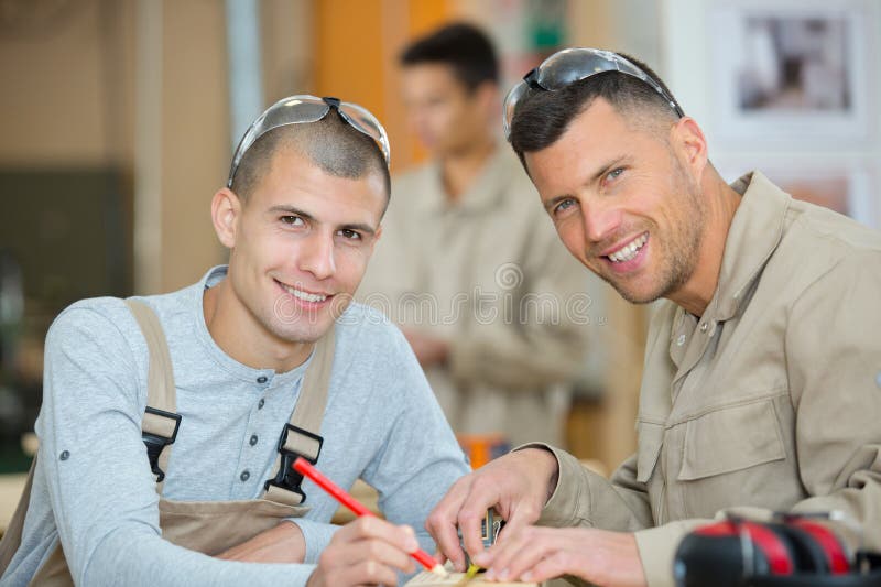 Two Smiling Technicians in Workshop Stock Photo - Image of technology ...