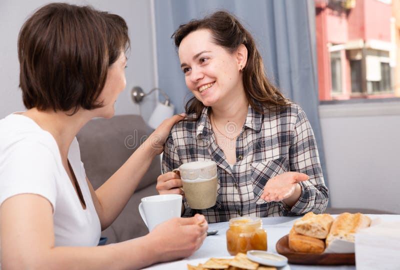 Smiling Women Drinking Tea with Cookies in the Kitchen Stock Photo ...