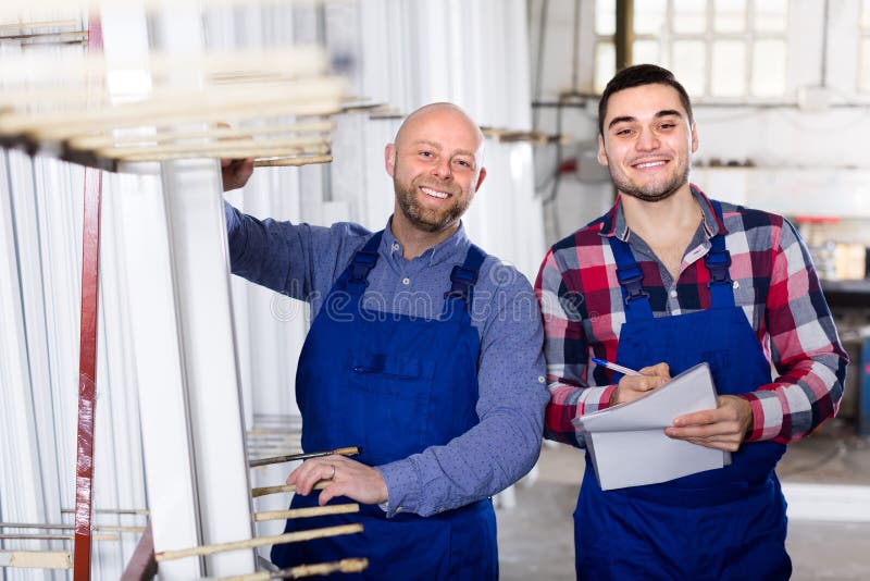 Two Smiling Workmen at Factory Stock Photo - Image of effective, indoor ...