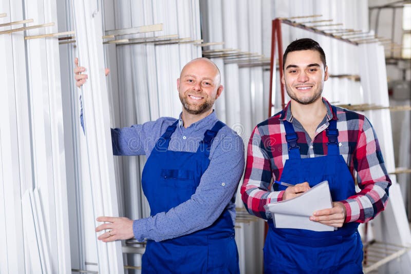 Two Smiling Workmen at Factory Stock Photo - Image of effective, indoor ...