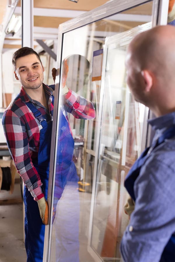 Two Smiling Workmen at Factory Stock Image - Image of roll, facility ...